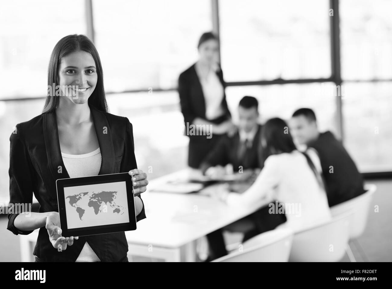 happy young business woman with her staff, people group in background ...