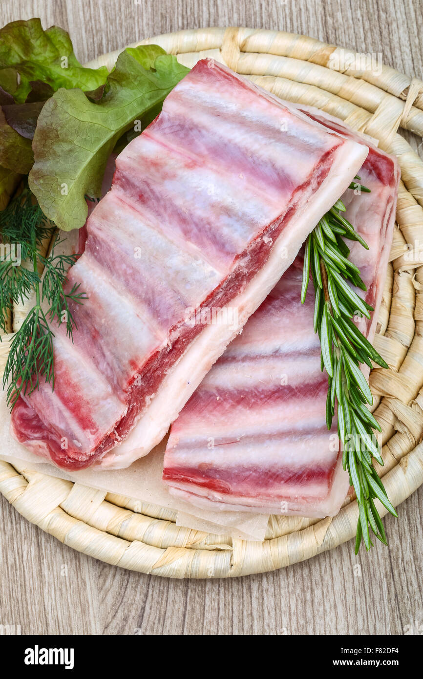 Fresh raw Lamb ribs with rosemary on the wood background Stock Photo ...