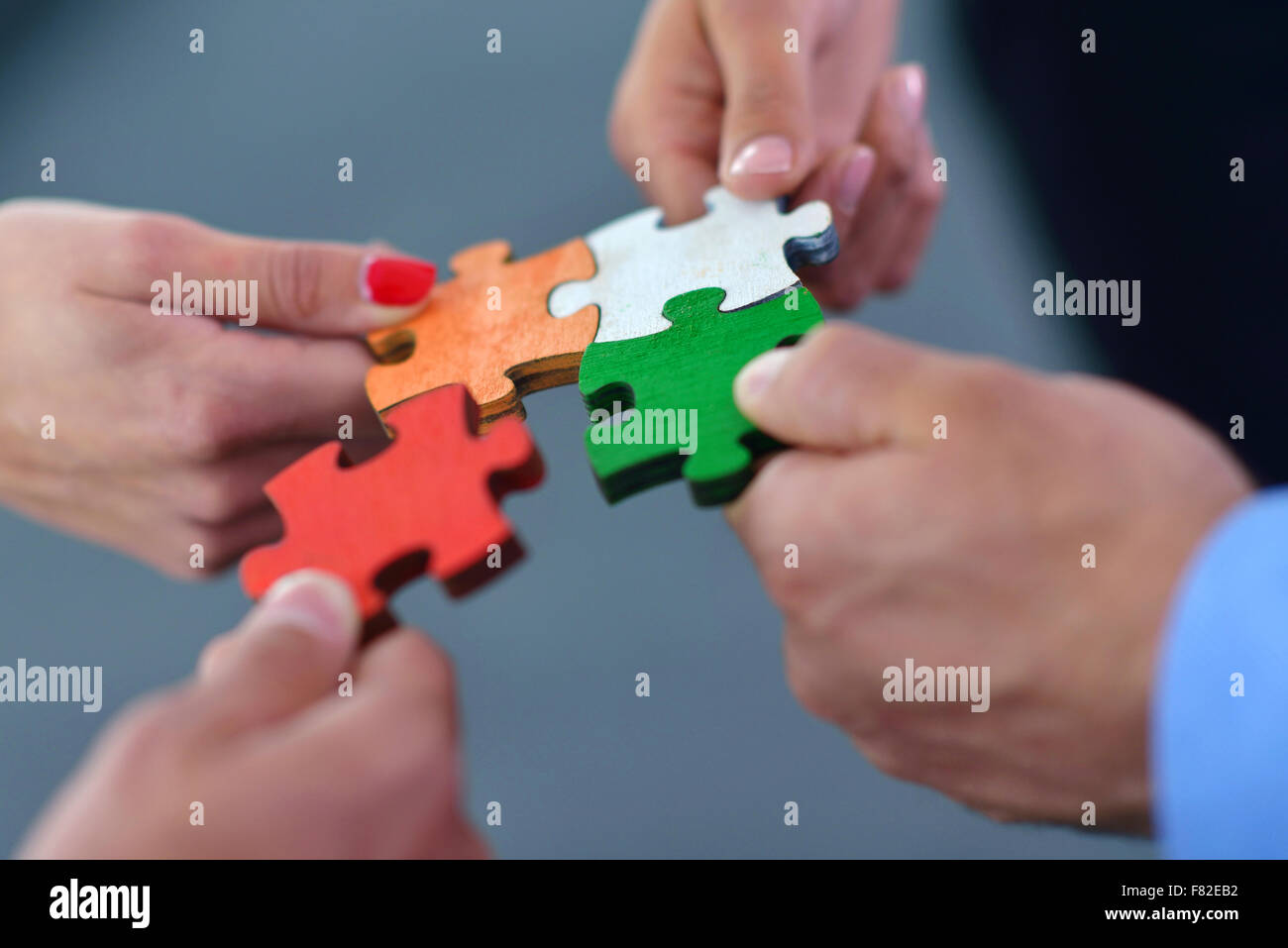 Group of business people assembling jigsaw puzzle and represent team ...