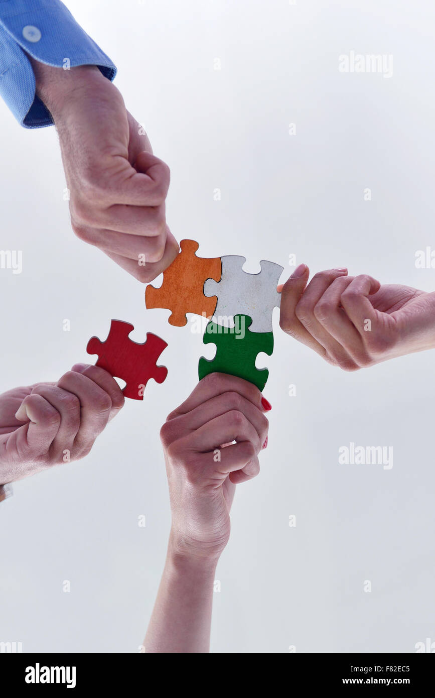 Group of business people assembling jigsaw puzzle and represent team ...