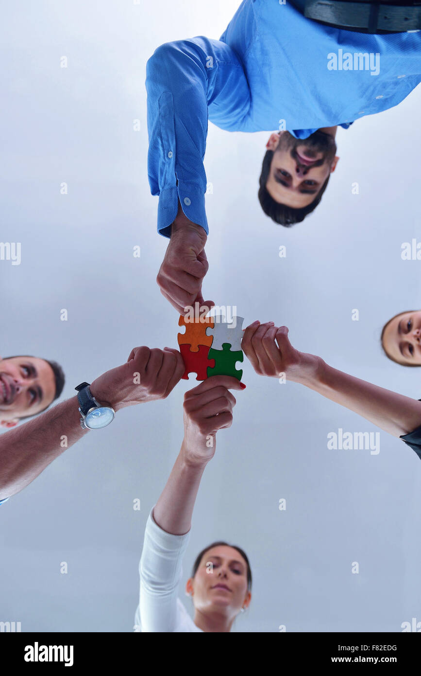 Group of business people assembling jigsaw puzzle and represent team ...