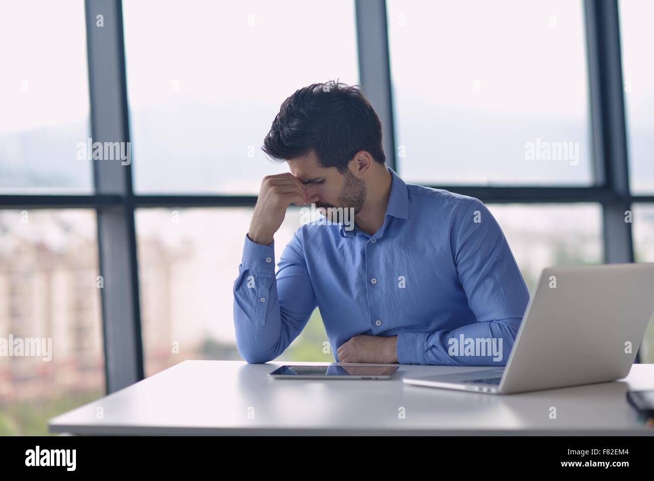 Young business man with problems and stress in the office Stock Photo ...
