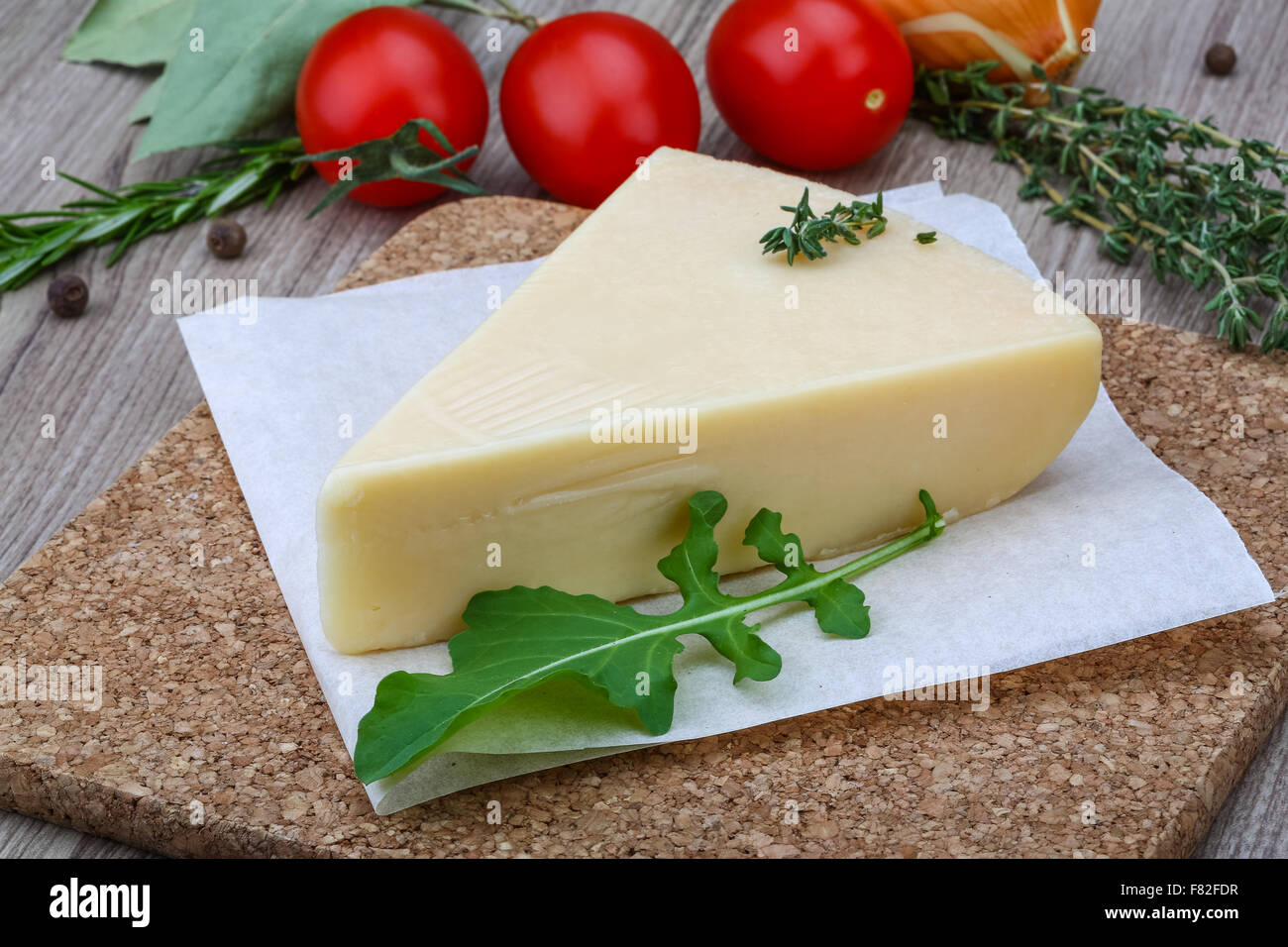 Italian Parmesan cheese with herbs on the wood background Stock Photo ...