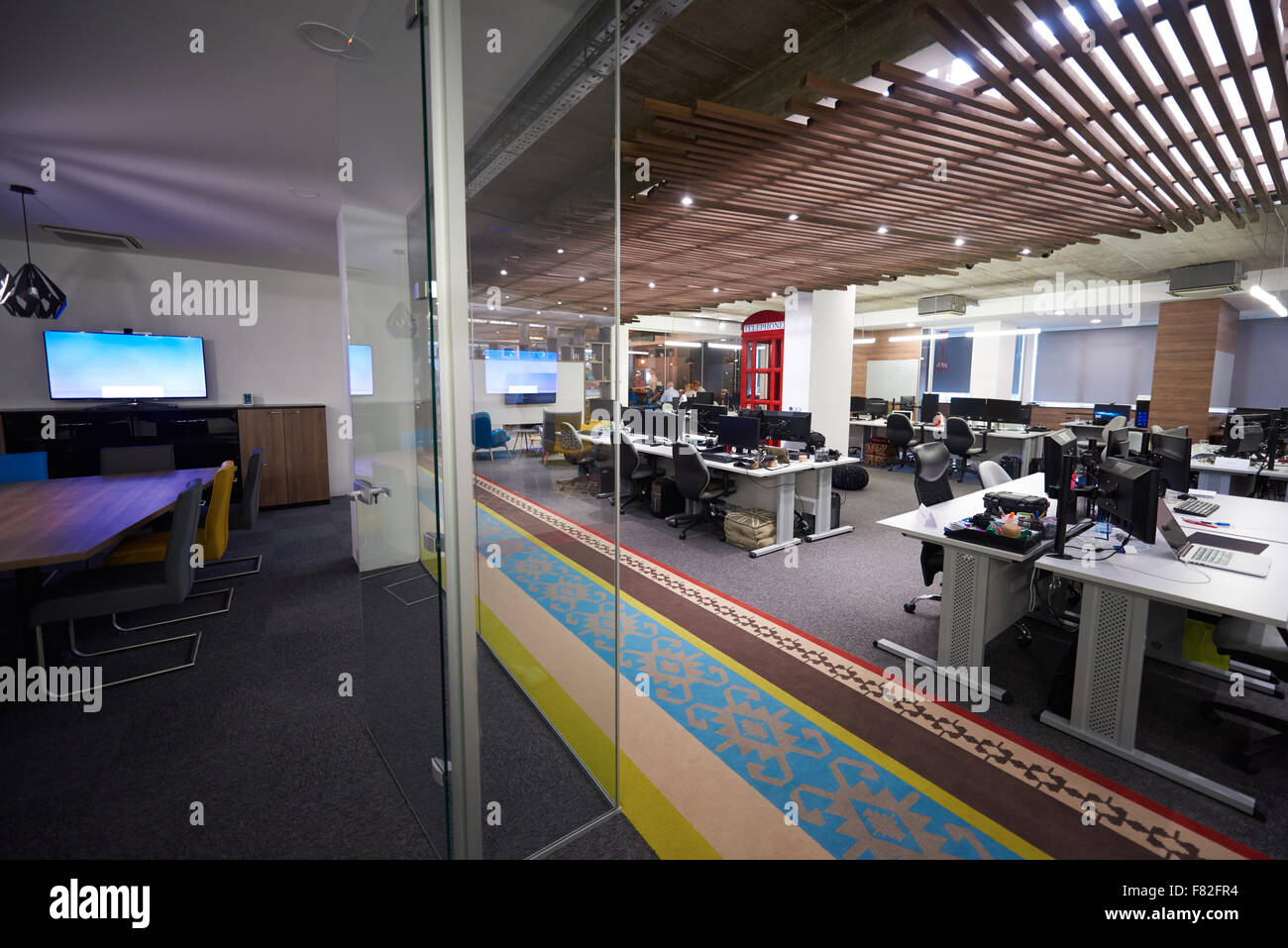 dual monitor screen and laptop computer at modern office indoors ...