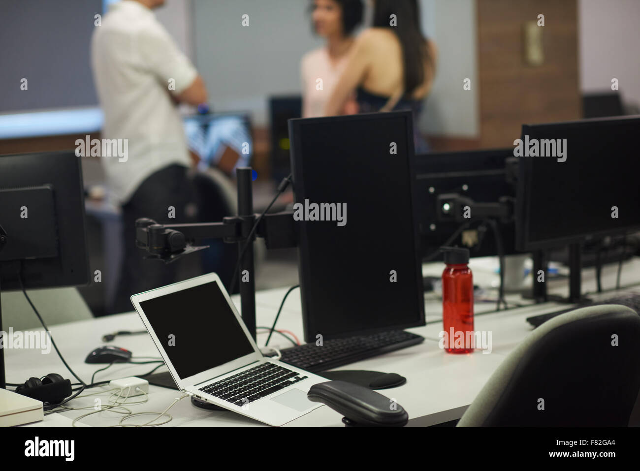 dual monitor screen and laptop computer at modern office indoors ...