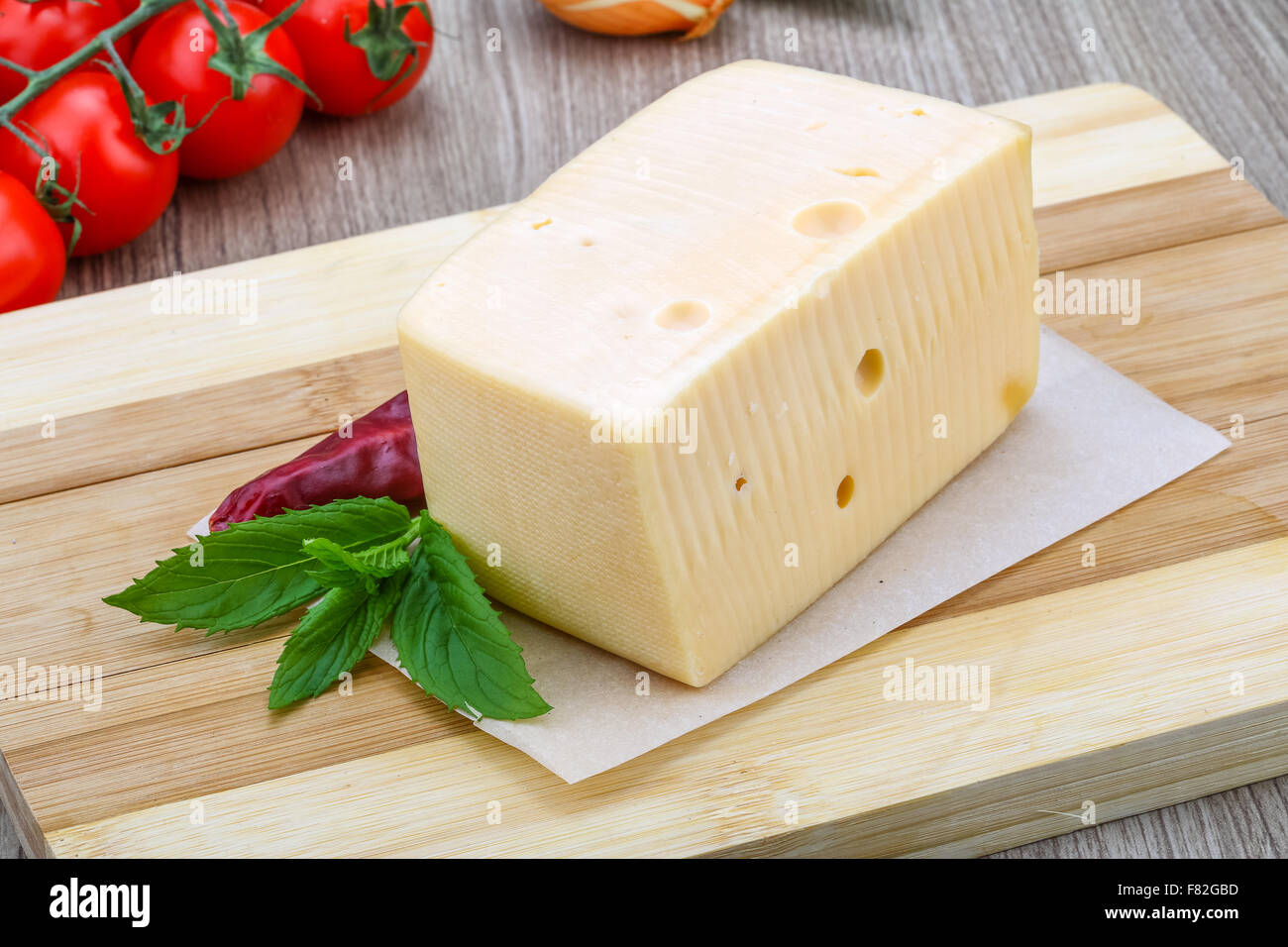 Yellow cheese brick with mint leaves on the wood background Stock Photo ...