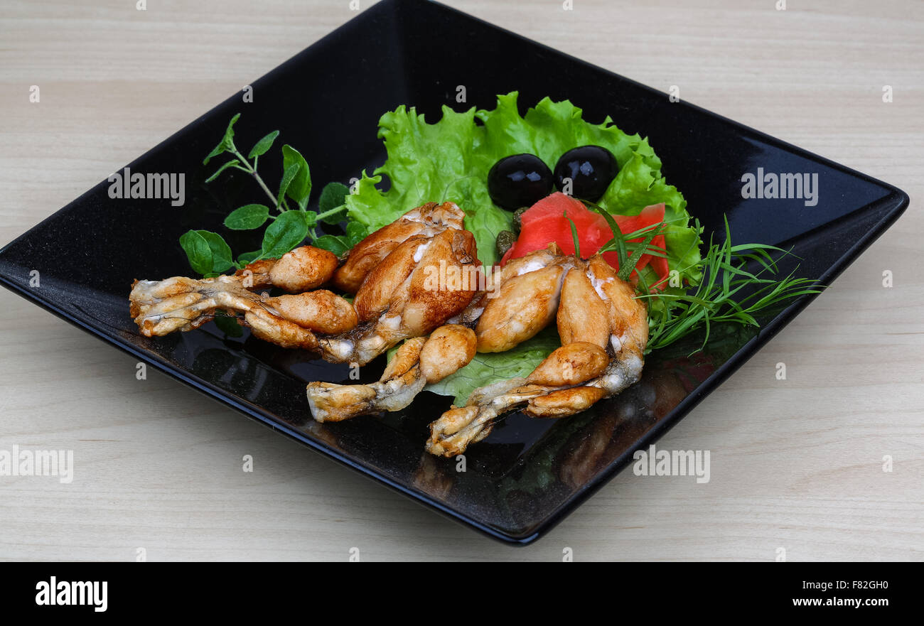 Roasted Frog legs with herbs and spices Stock Photo - Alamy