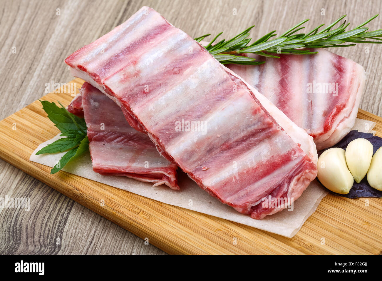 Fresh cold Raw lamb ribs with garlik and pepper - ready for cooking ...