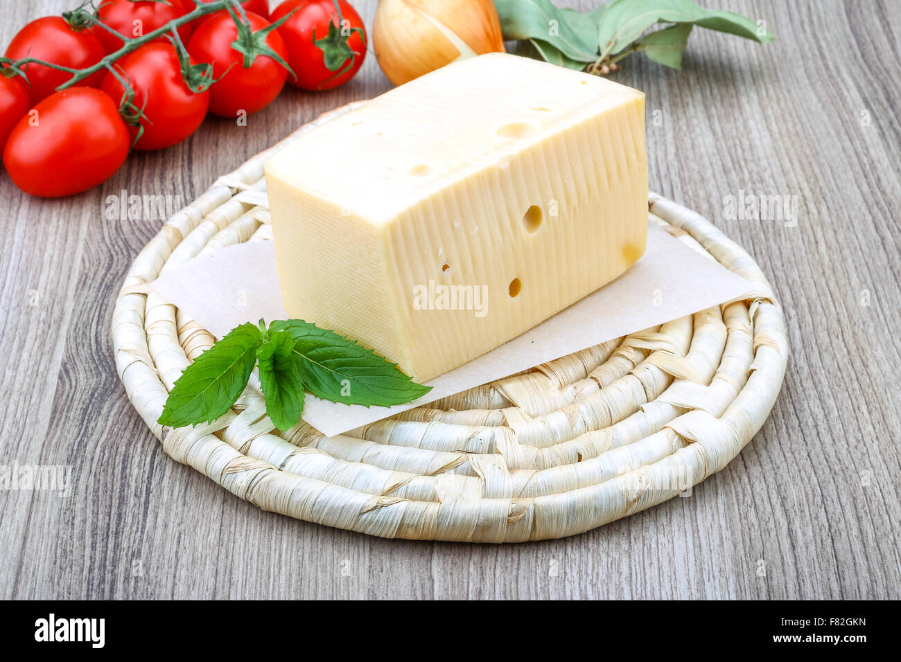 Yellow cheese brick with mint leaves on the wood background Stock Photo ...