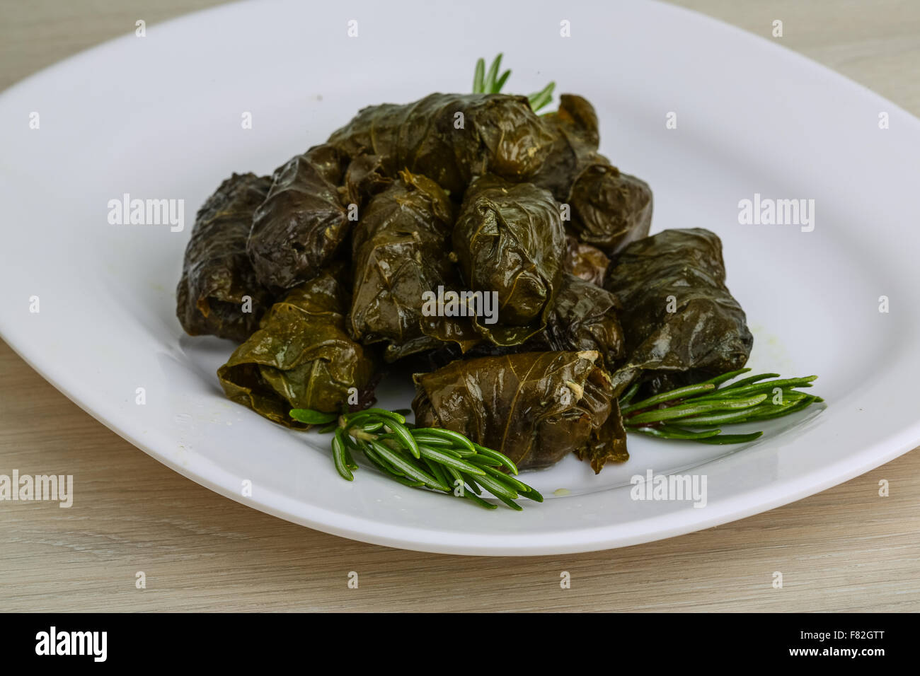 Greek dolma in grape leaves with meat served rosemary Stock Photo - Alamy