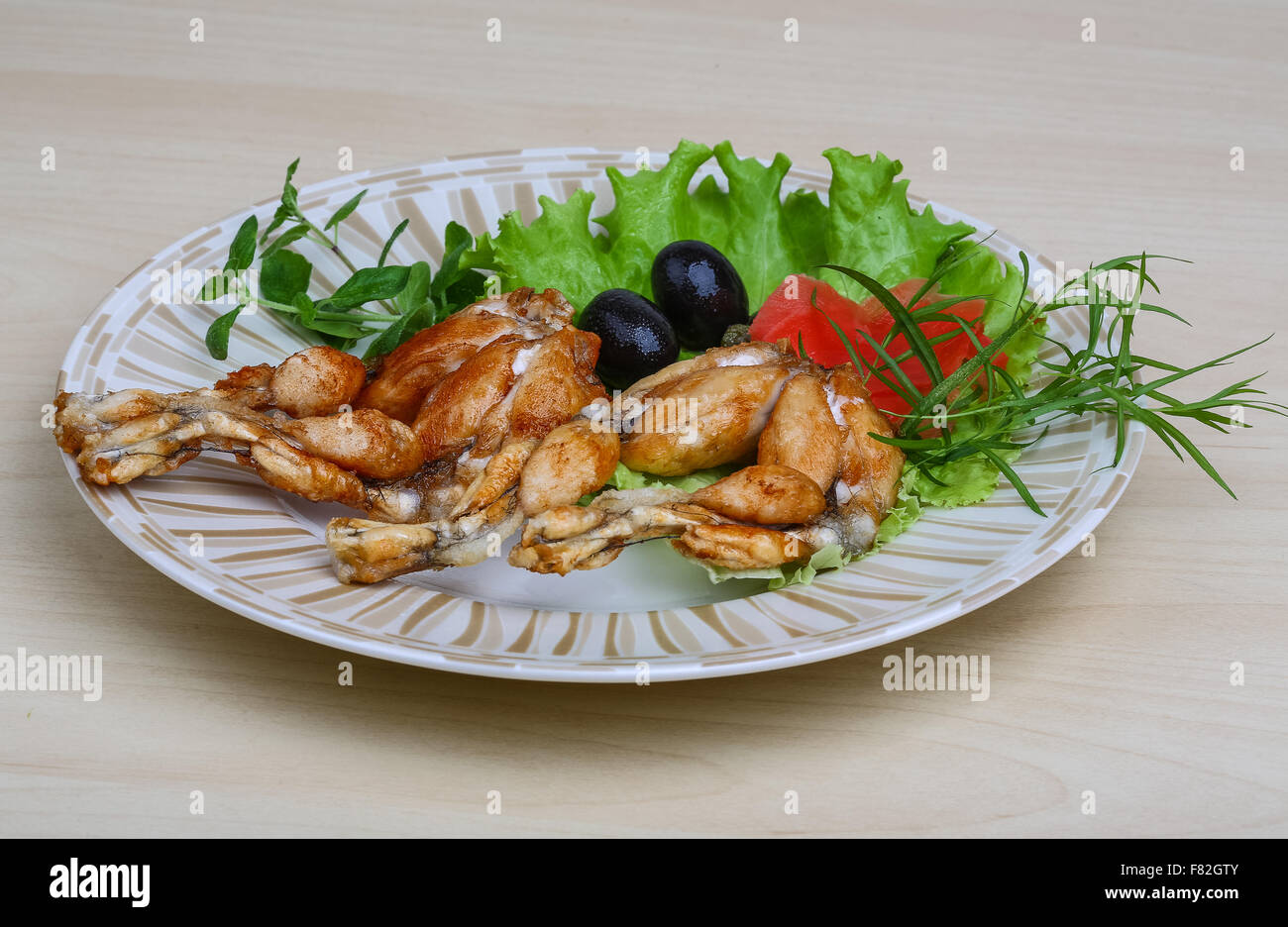 Roasted Frog legs with herbs and spices Stock Photo - Alamy