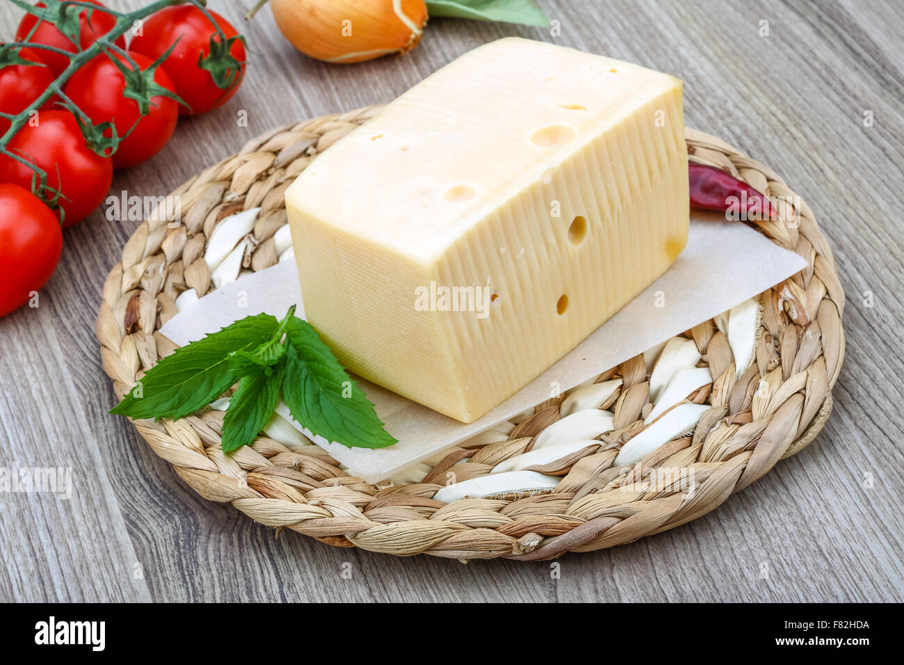 Yellow cheese brick with mint leaves on the wood background Stock Photo ...