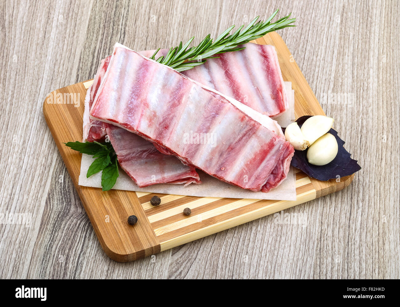 Fresh cold Raw lamb ribs with garlik and pepper - ready for cooking ...