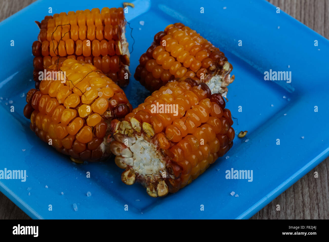 Grilled salted corn on the wood background Stock Photo - Alamy