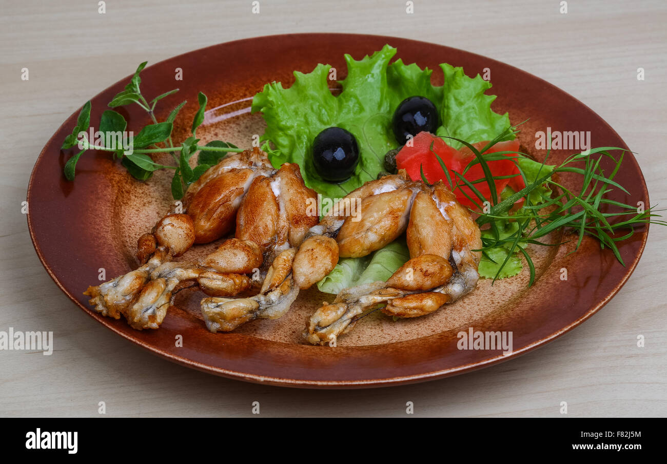 Roasted Frog legs with herbs and spices Stock Photo - Alamy