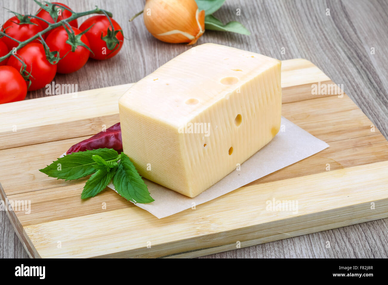 Yellow cheese brick with mint leaves on the wood background Stock Photo ...