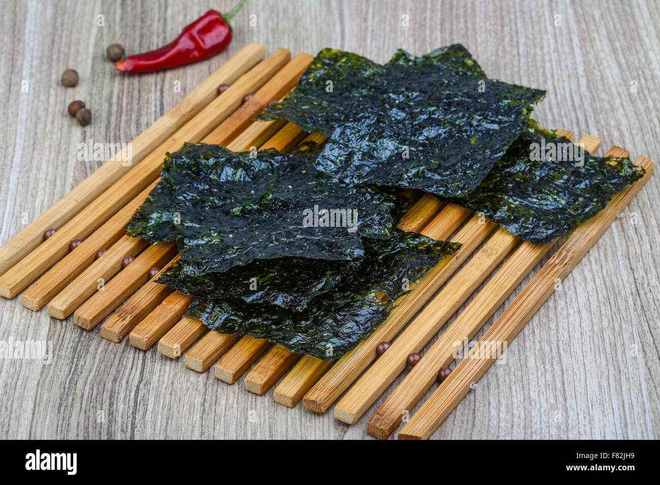 Korean traditional snack - Nori seaweed sheets on the wood background ...