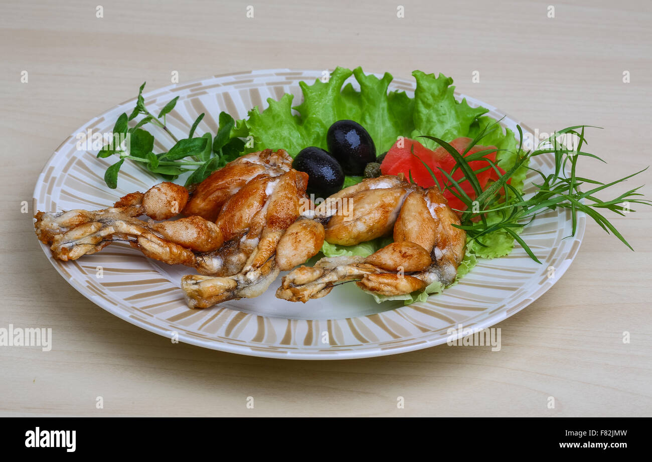 Roasted Frog legs with herbs and spices Stock Photo - Alamy