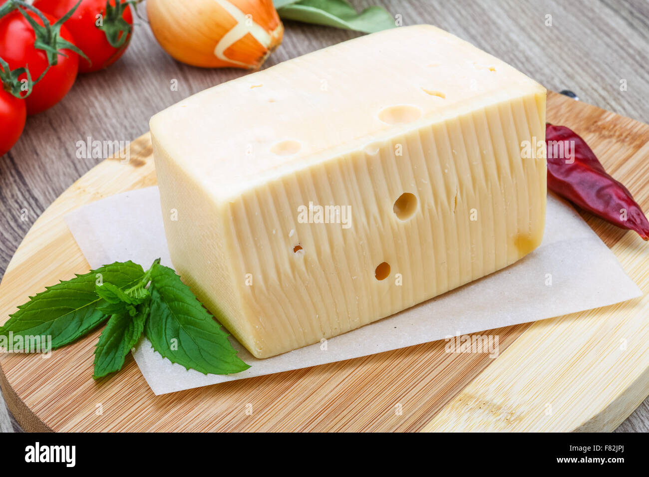 Yellow cheese brick with mint leaves on the wood background Stock Photo ...