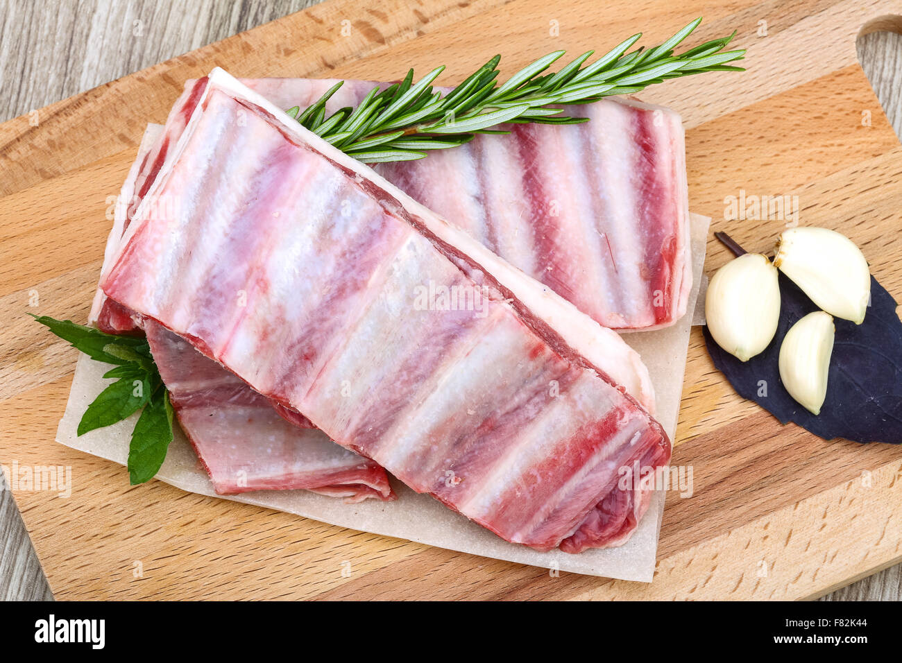Fresh cold Raw lamb ribs with garlik and pepper - ready for cooking ...