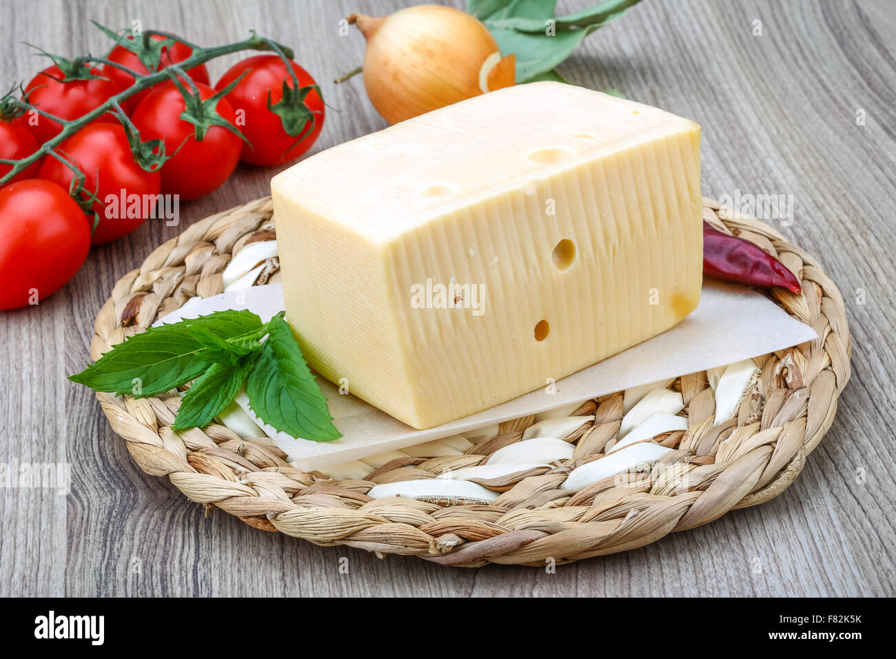 Yellow cheese brick with mint leaves on the wood background Stock Photo ...