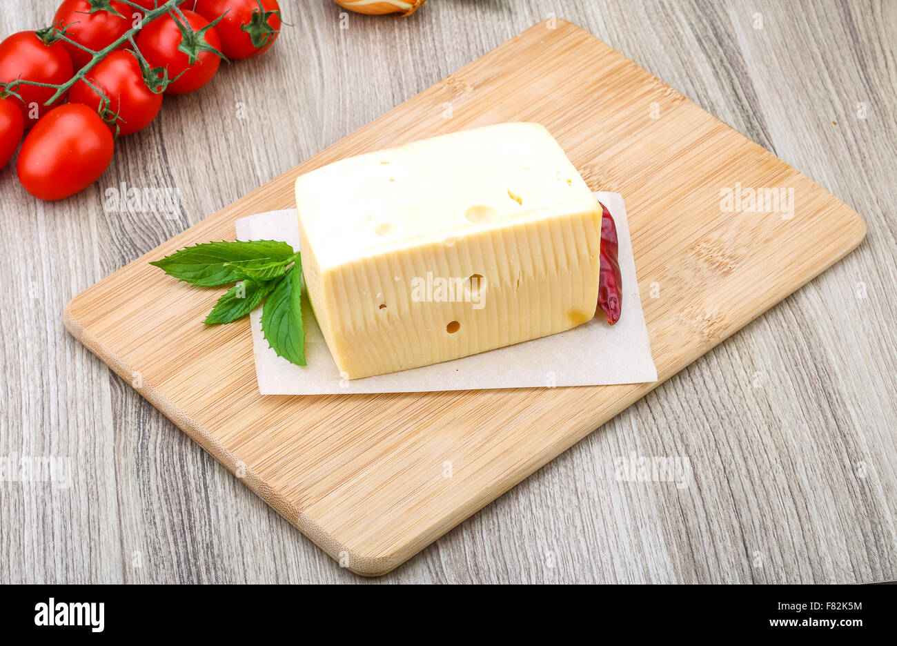 Yellow cheese brick with mint leaves on the wood background Stock Photo ...