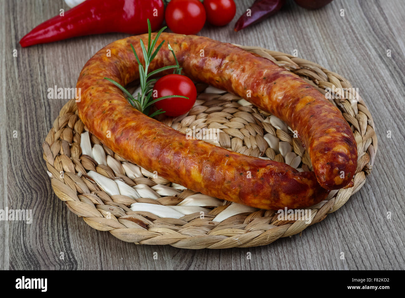 Sausage ring with rosemary and pepper on the wood background Stock ...