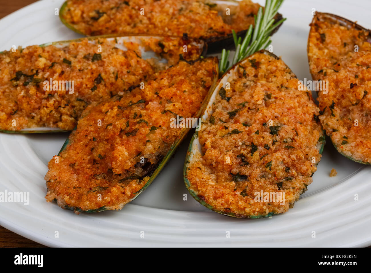Baked mussels with bread and spices served rosemary Stock Photo - Alamy