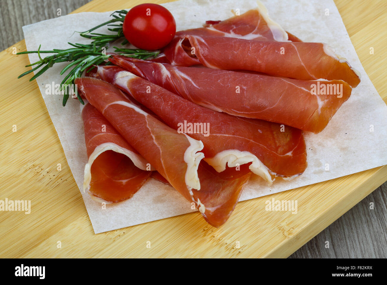 Spanish traditional snack - Jamon with tomato and rosemary Stock Photo ...