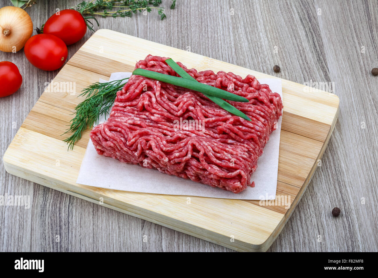 Raw minced beef meat with green oinion and dill Stock Photo - Alamy