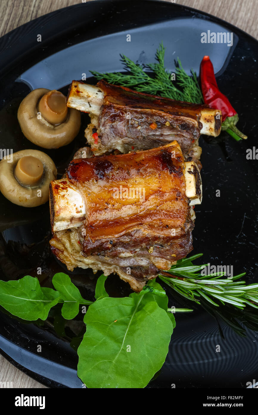 Roasted beef ribs with rosemary, ruccola and spices Stock Photo - Alamy