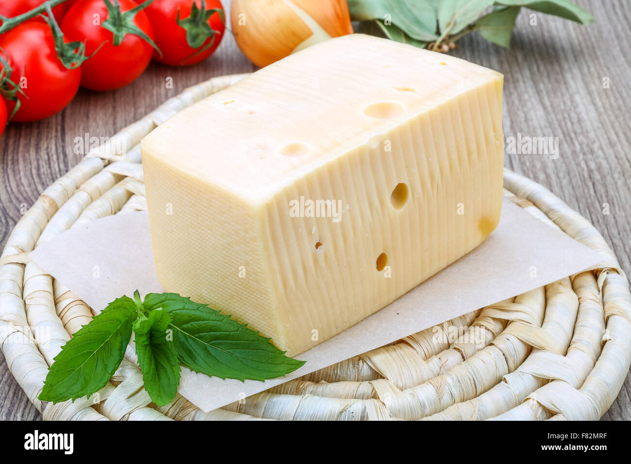 Yellow cheese brick with mint leaves on the wood background Stock Photo ...