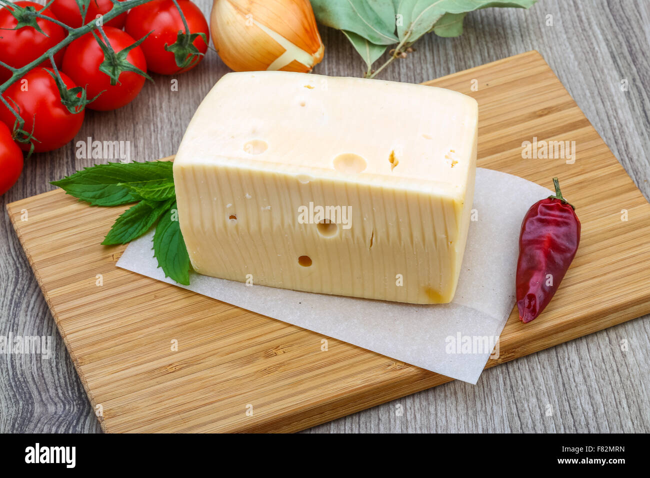 Yellow cheese brick with mint leaves on the wood background Stock Photo ...