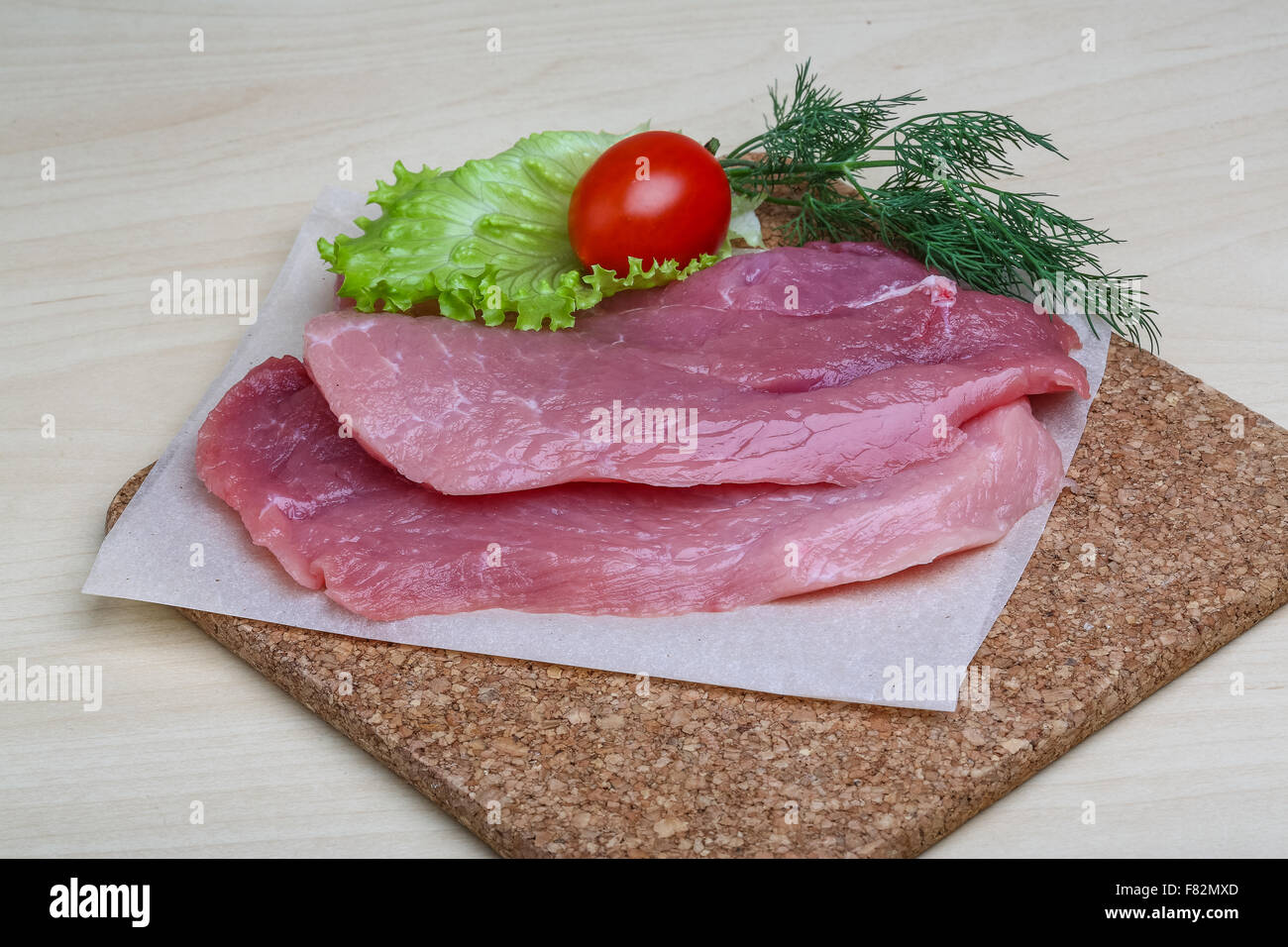 Raw pork schnitzel with dill - ready for cooking Stock Photo - Alamy