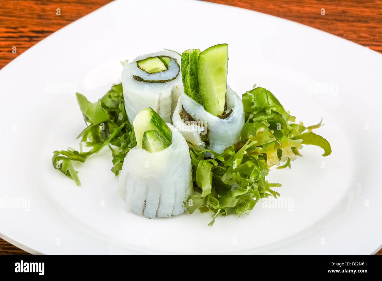 Fresh cold Squid sashimi with cucumber and nori Stock Photo - Alamy