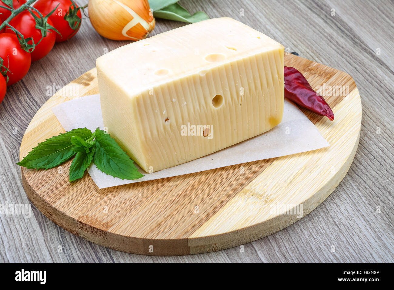 Yellow cheese brick with mint leaves on the wood background Stock Photo ...