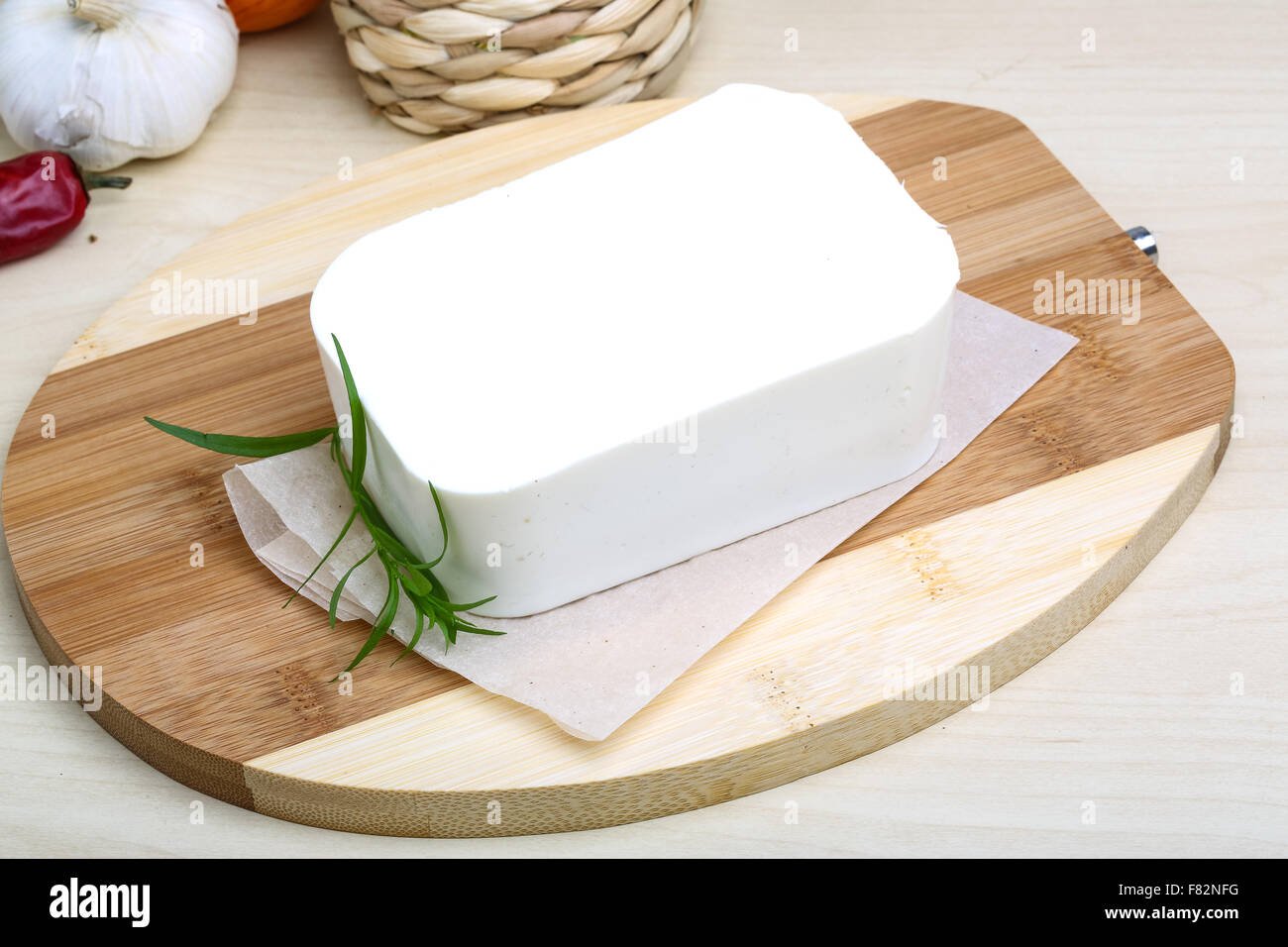 Feta cheese slice on the board with terragon Stock Photo - Alamy