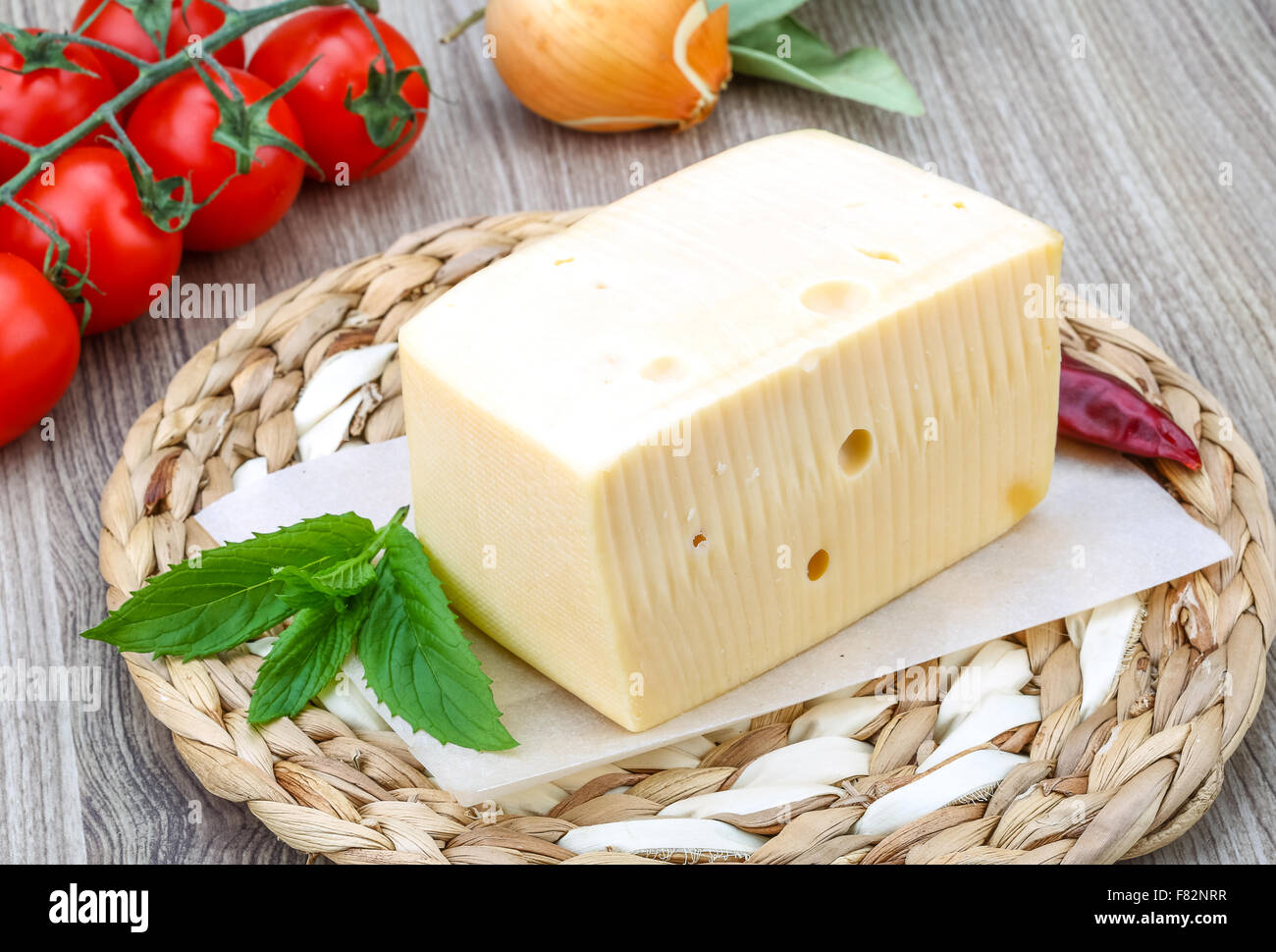 Yellow cheese brick with mint leaves on the wood background Stock Photo ...