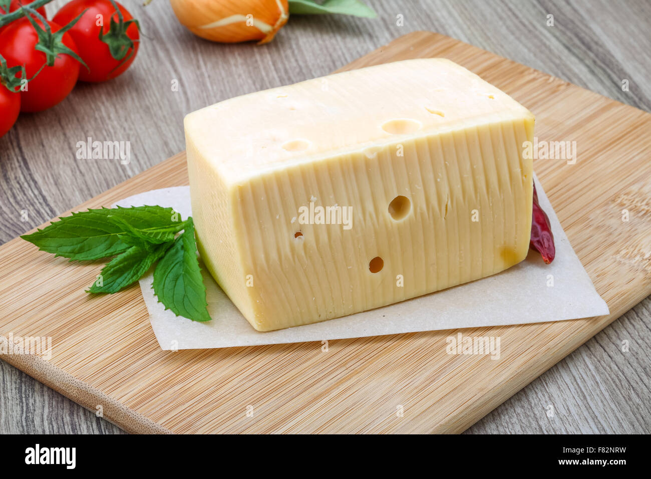 Yellow cheese brick with mint leaves on the wood background Stock Photo ...