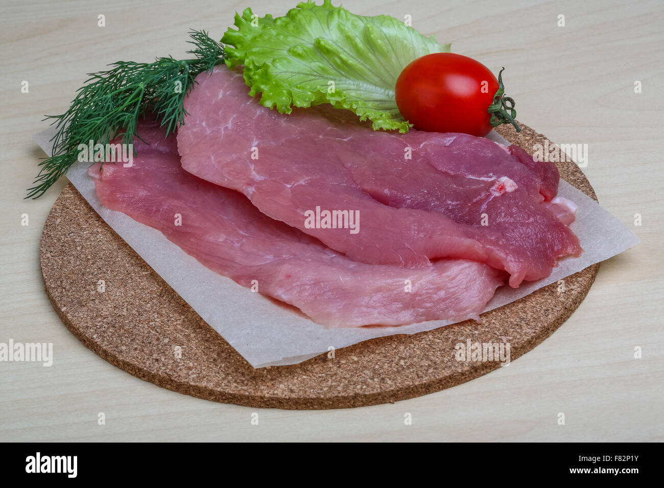Raw pork schnitzel with dill - ready for cooking Stock Photo - Alamy