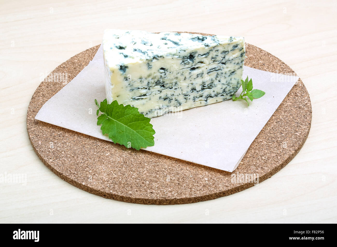 Dor Blue cheese with basil on the wood background Stock Photo - Alamy