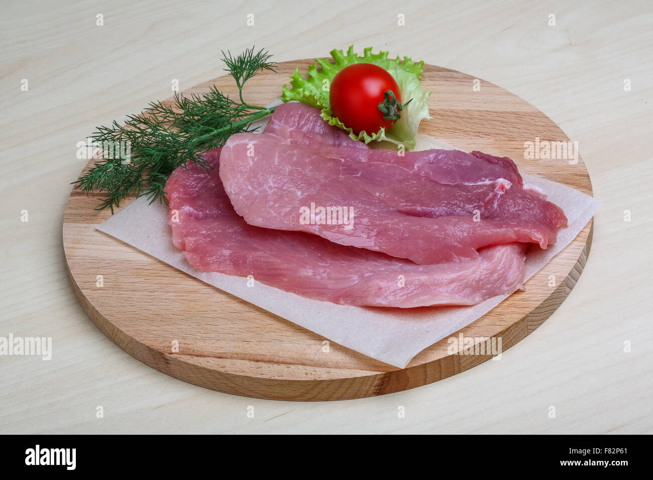 Raw pork schnitzel with dill - ready for cooking Stock Photo - Alamy