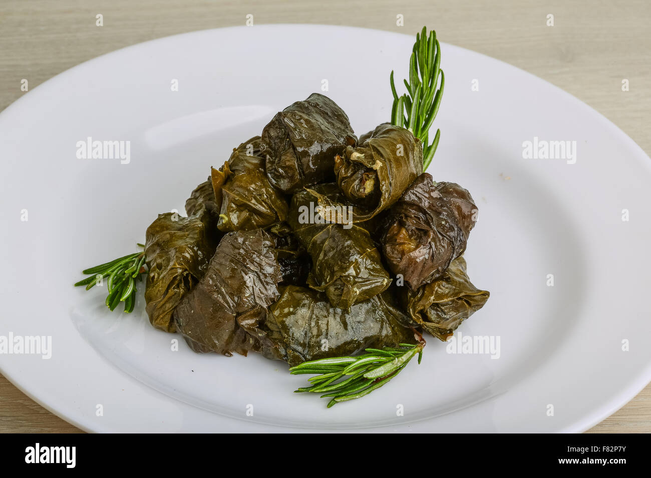 Greek dolma in grape leaves with meat served rosemary Stock Photo - Alamy