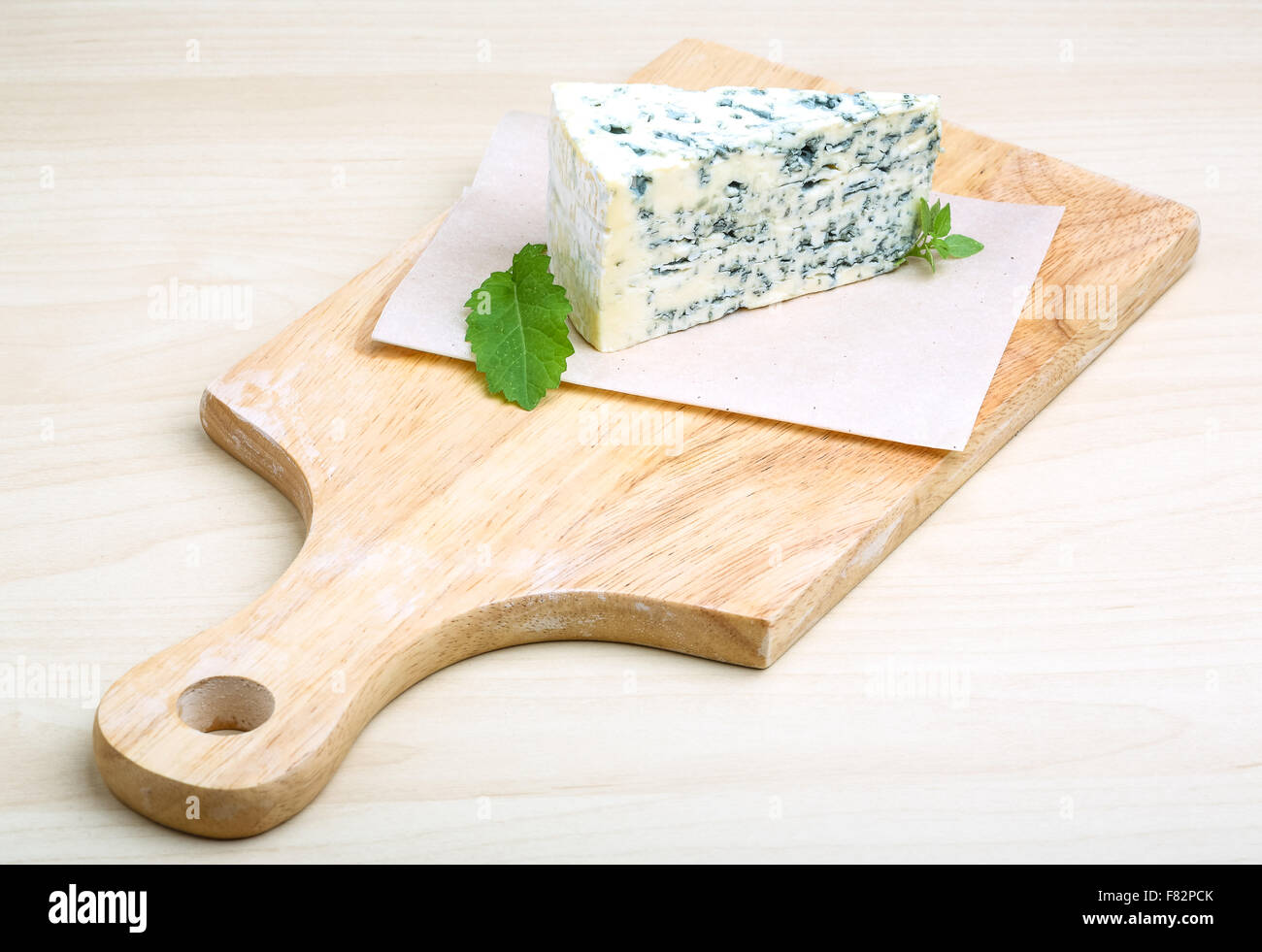 Dor Blue cheese with basil on the wood background Stock Photo - Alamy