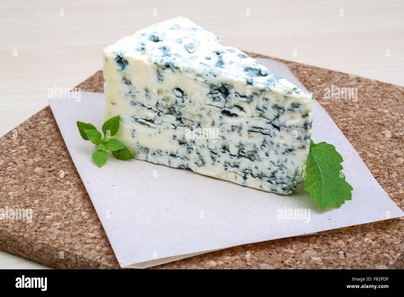 Dor Blue cheese with basil on the wood background Stock Photo - Alamy