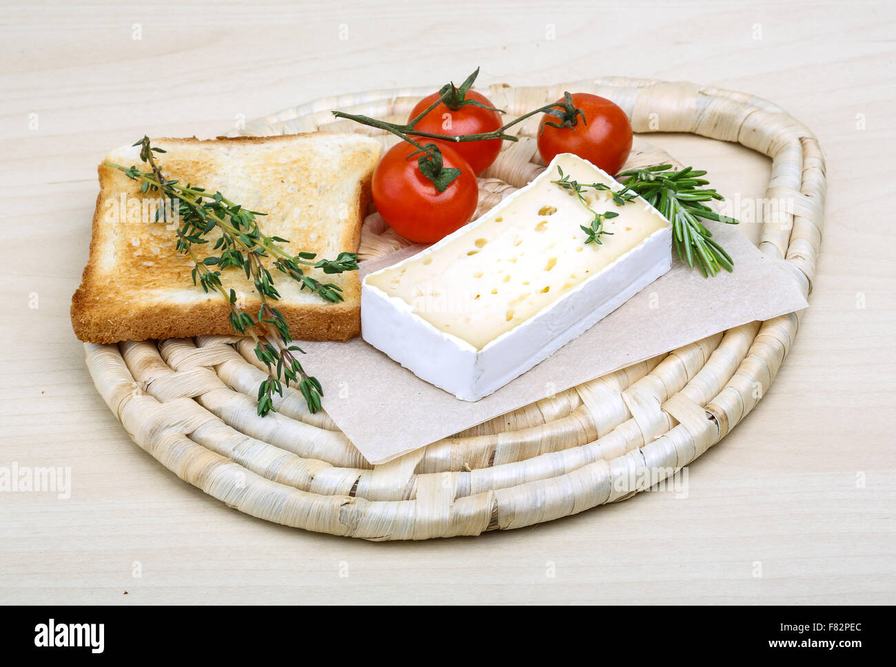 Soft brie cheese with rosemary, thyme and toast bread Stock Photo - Alamy