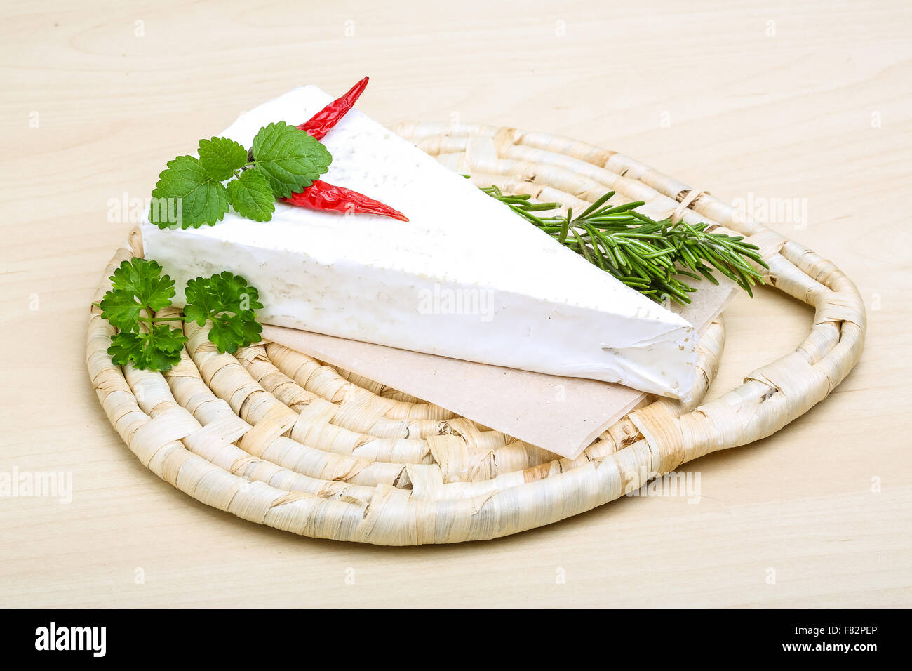 Soft brie cheese with rosemary, thyme on the wood background Stock ...