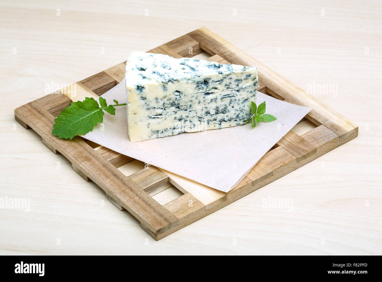 Dor Blue cheese with basil on the wood background Stock Photo - Alamy
