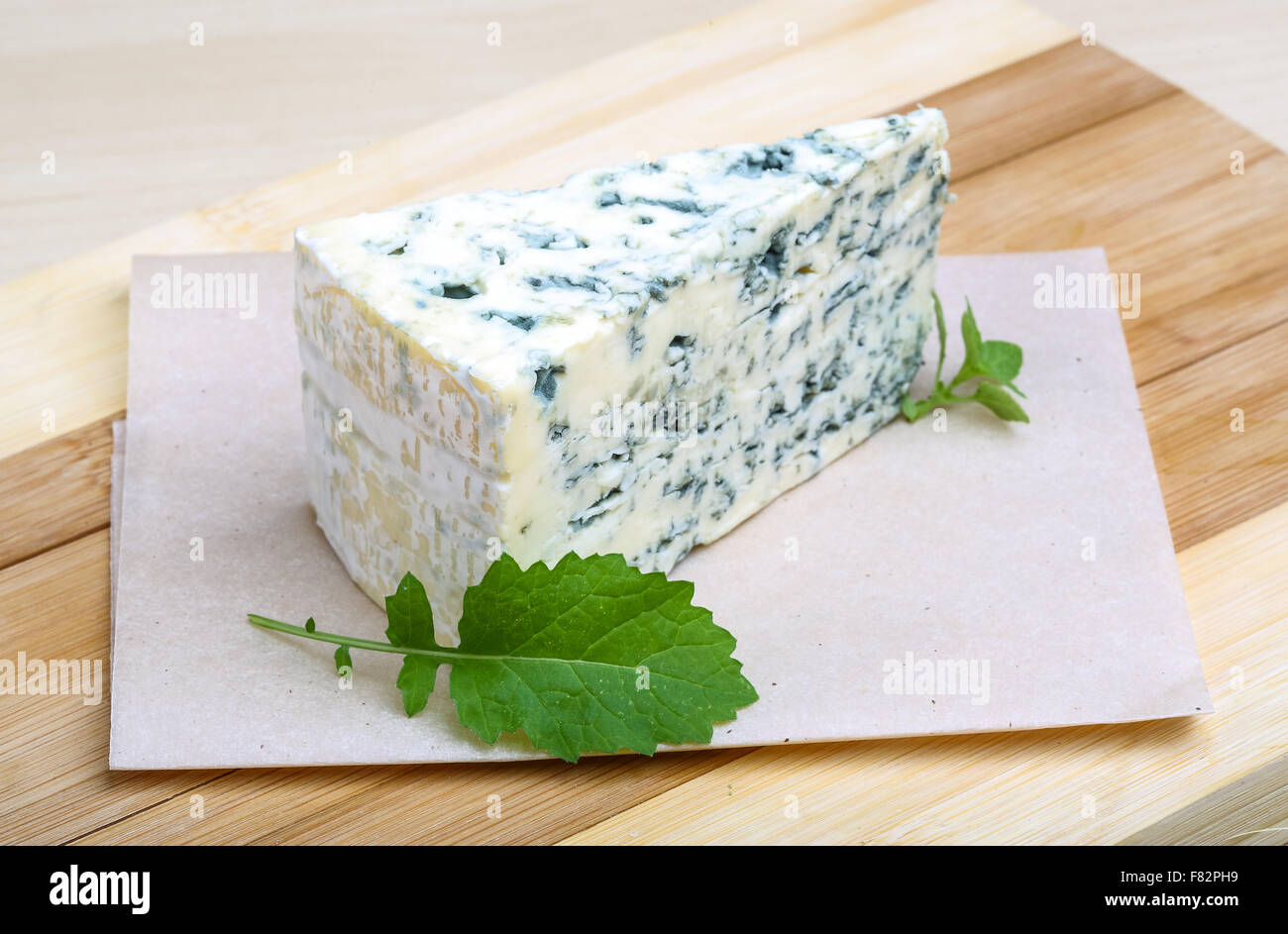 Dor Blue cheese with basil on the wood background Stock Photo - Alamy