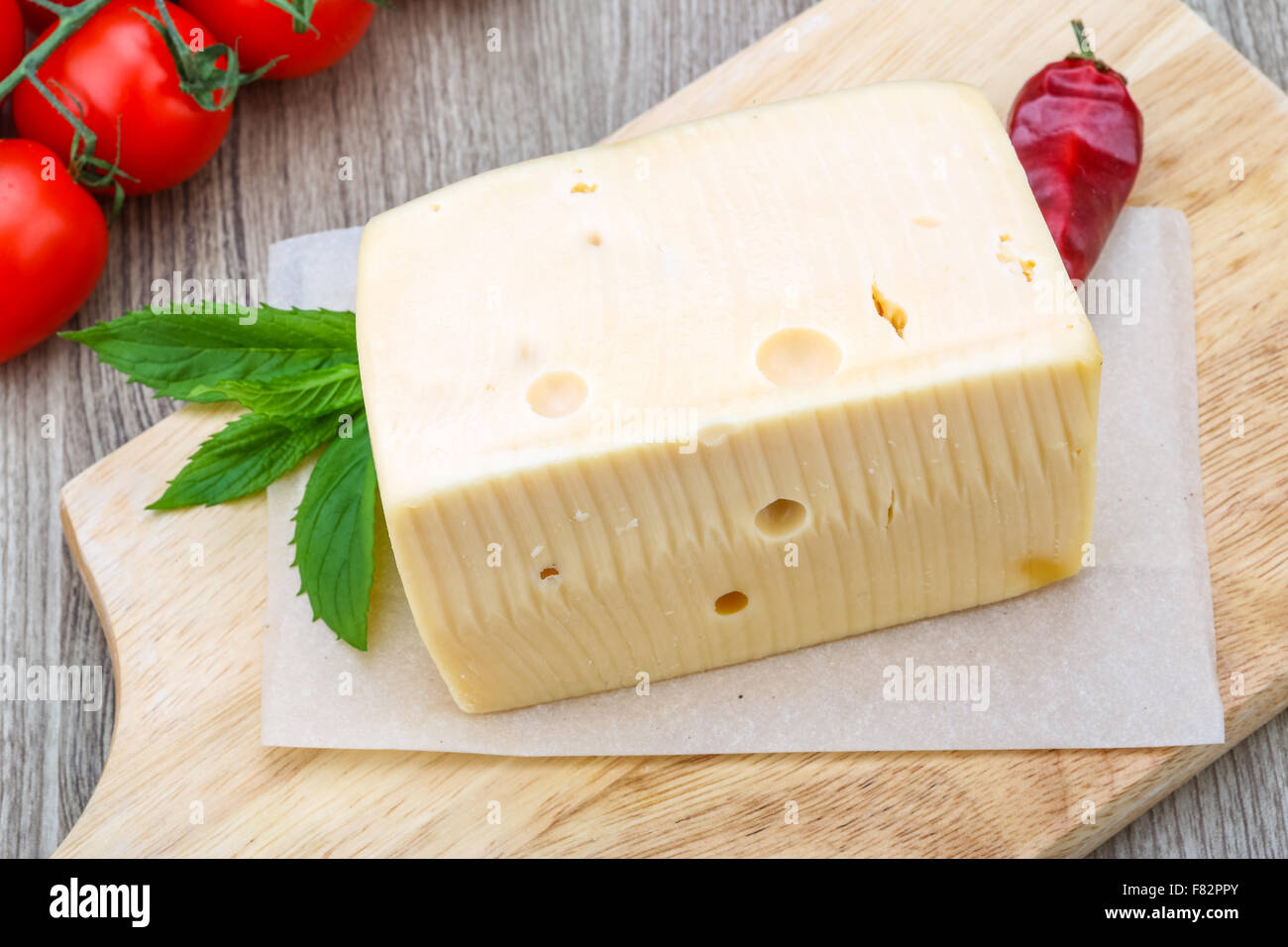Yellow cheese brick with mint leaves on the wood background Stock Photo ...
